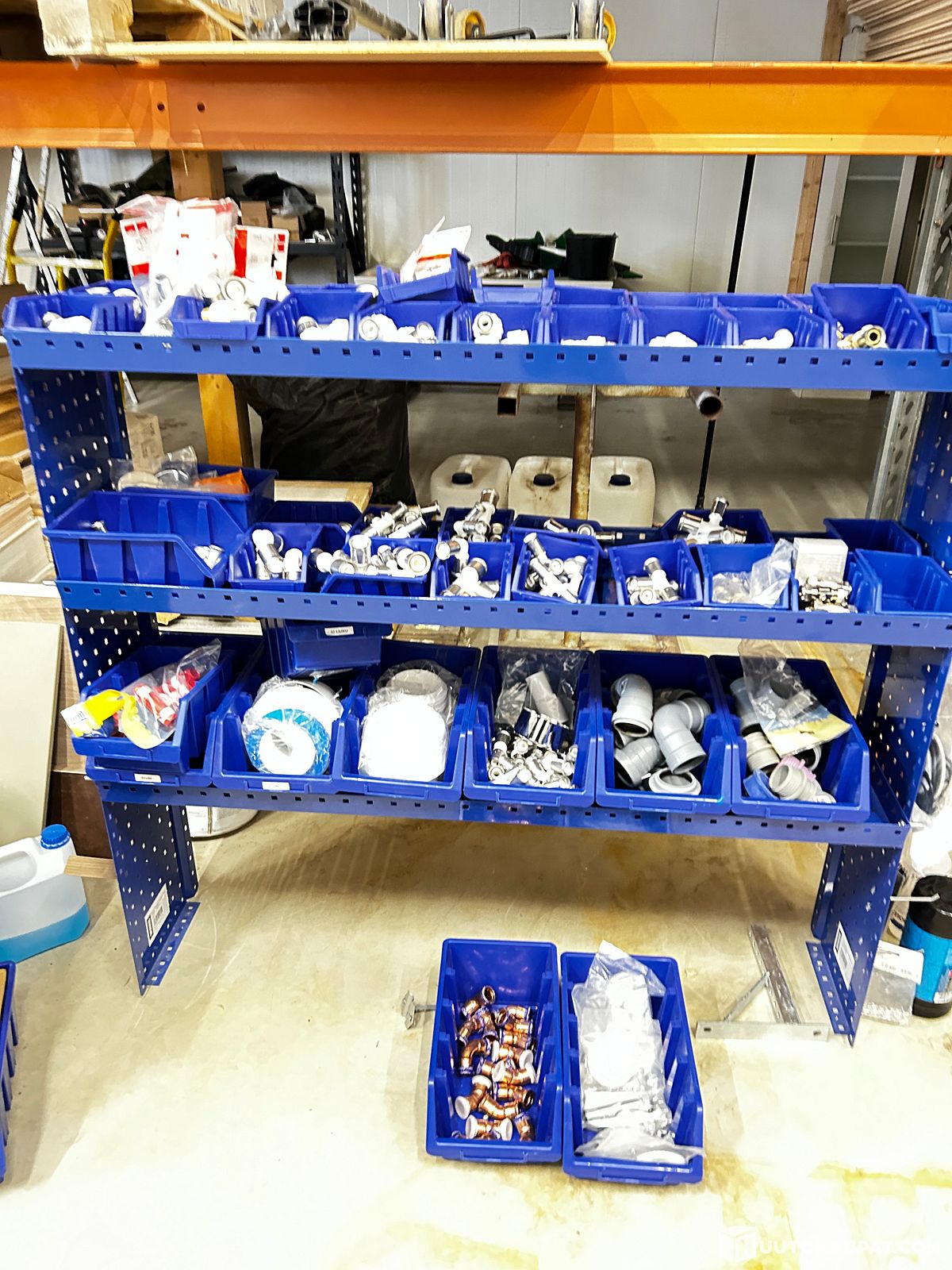 Various pipe fittings and a vehicle shelf containing the items ...